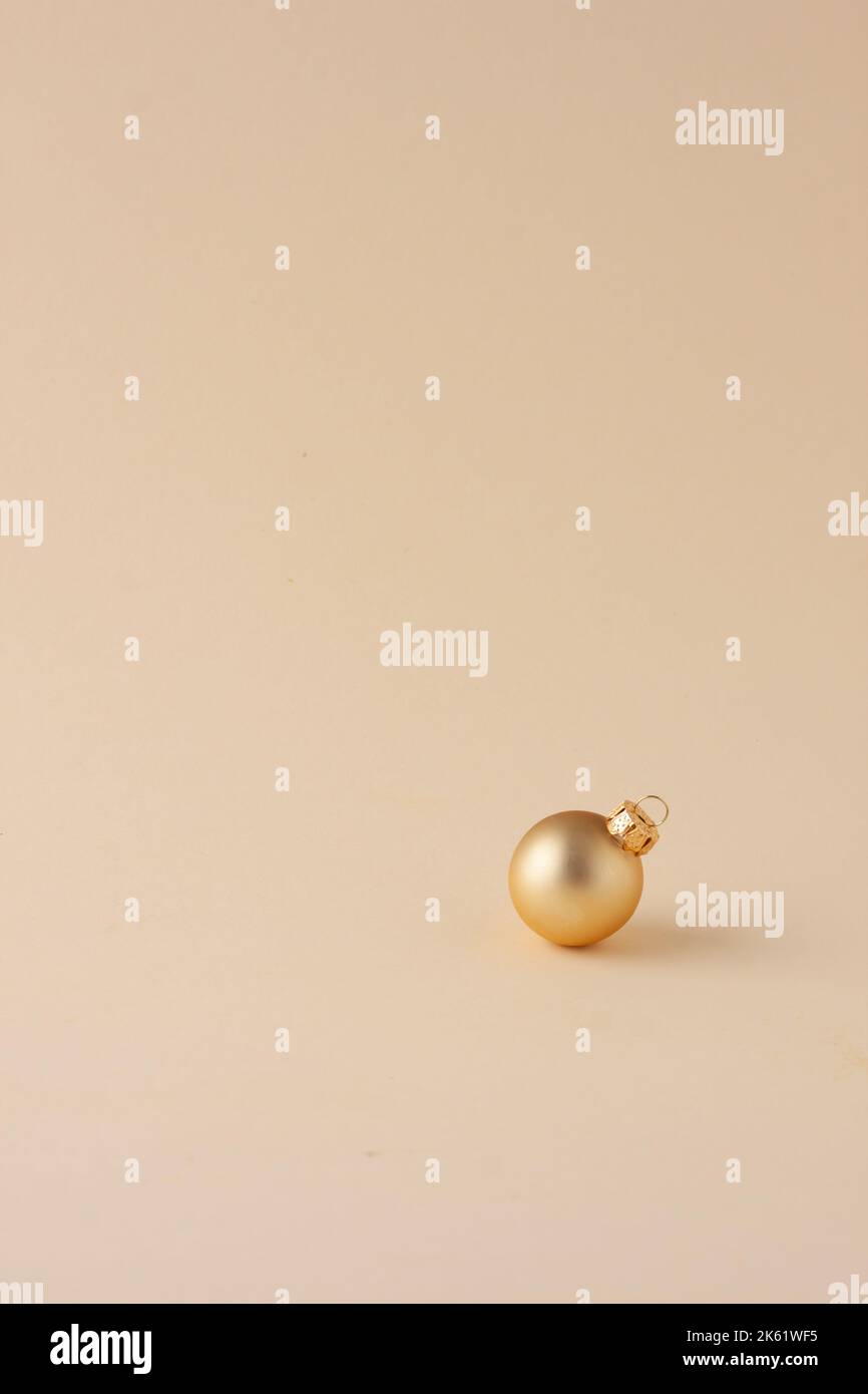 Christmas pastel beige minimal background with beige ball. Close up ...