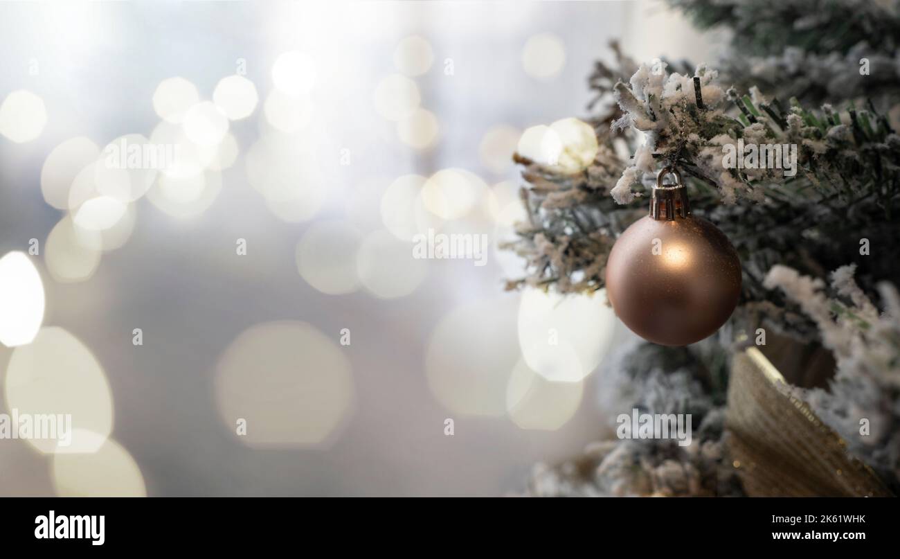 Golden ball on christmas tree with bokeh background. Happy New Year and ...