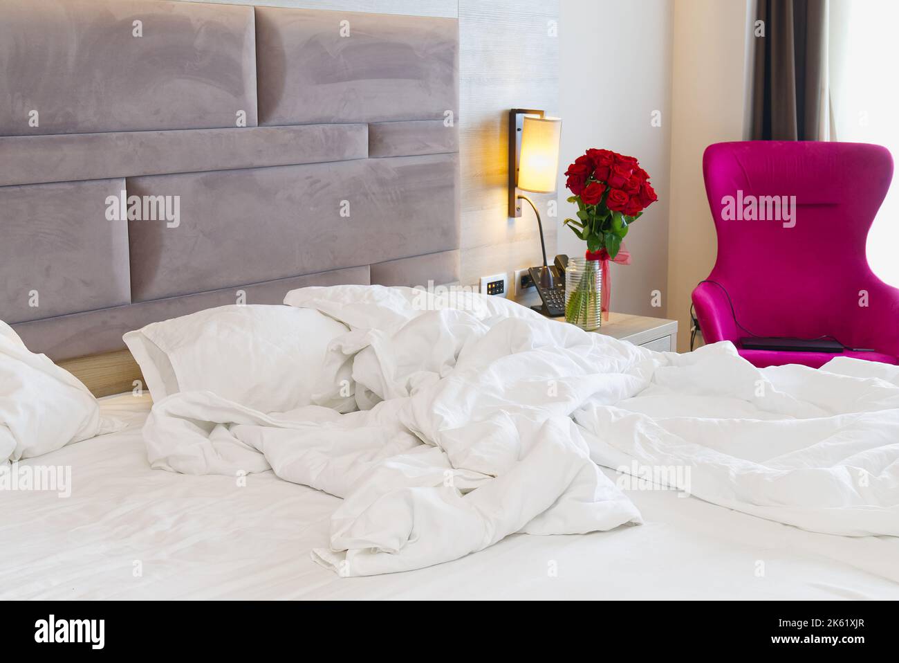 wrinkled bed after a stormy night of love. Closeup on soft white and ...