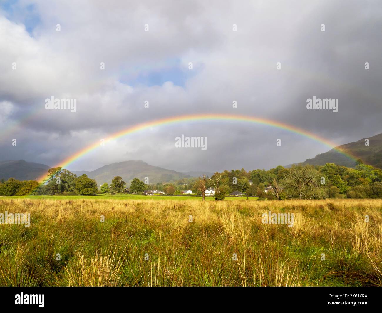 A rainbow from a passing shower over Ambleside, Lake District, UK Stock ...