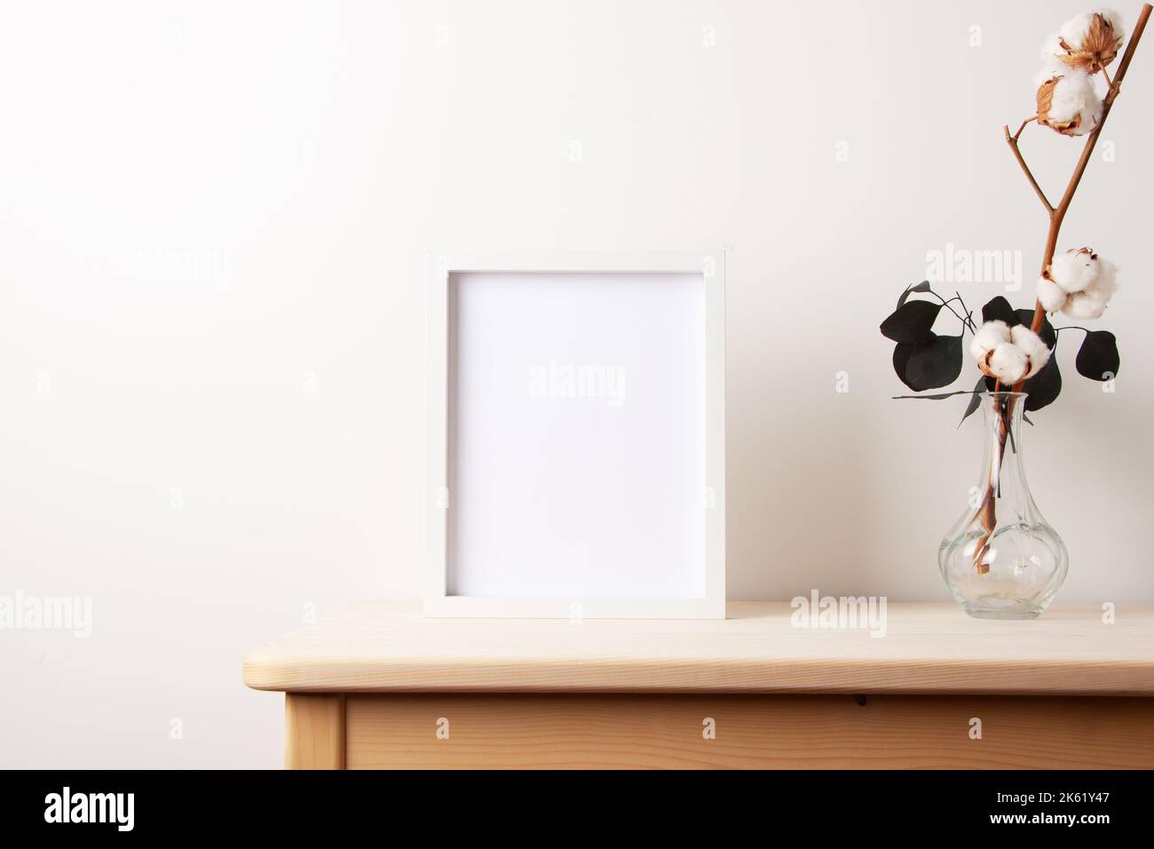 Home decoration with white mock up frame on table. Artwork showcase ...