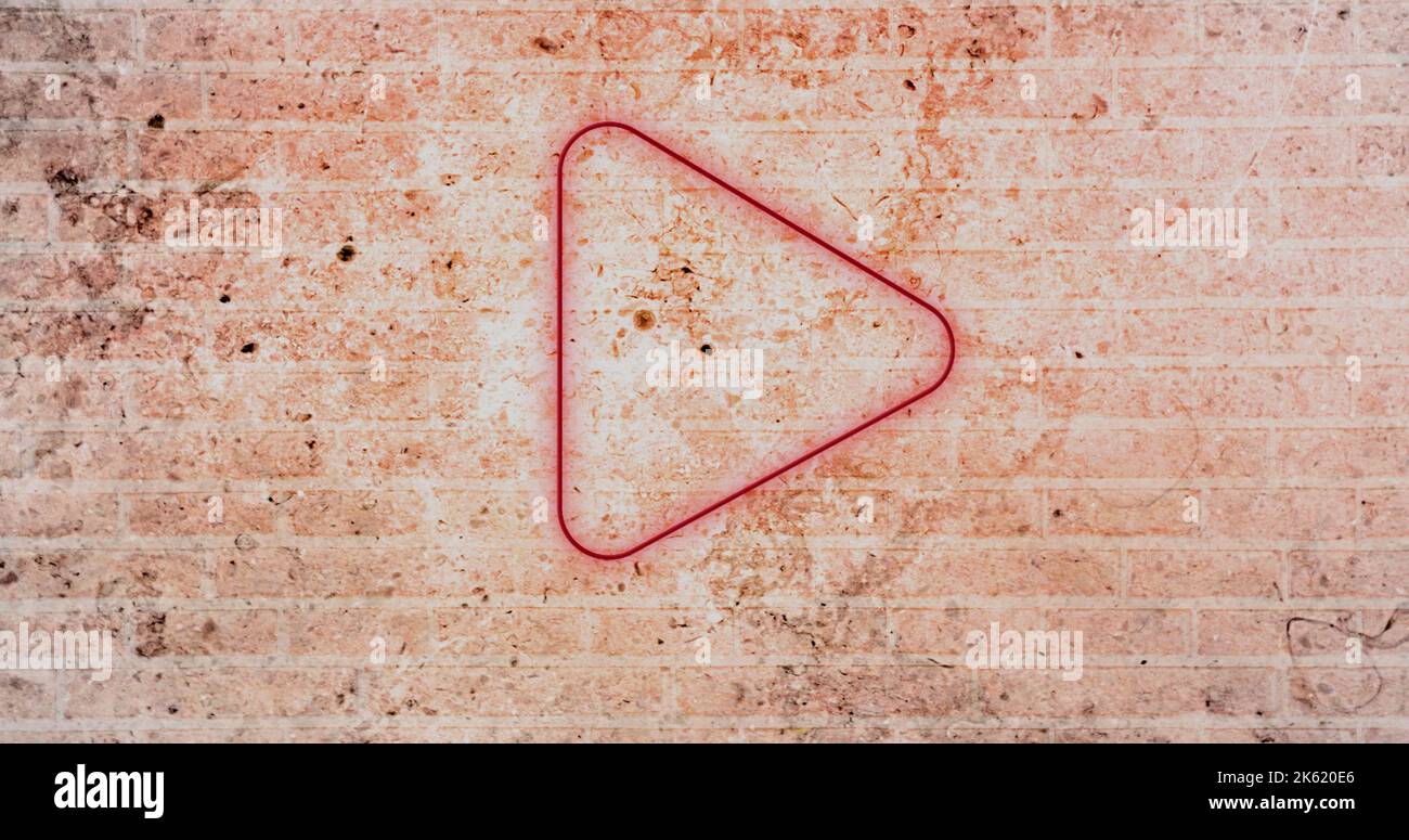 Composite of digital illuminated red play button icon against grunge ...