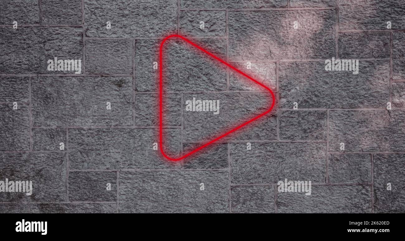 Composite of digital red play button icon against gray textured wall ...