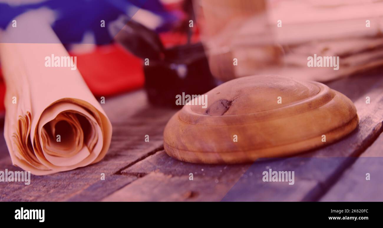 Close-up of wooden sound block and legal documents rolled up on table ...