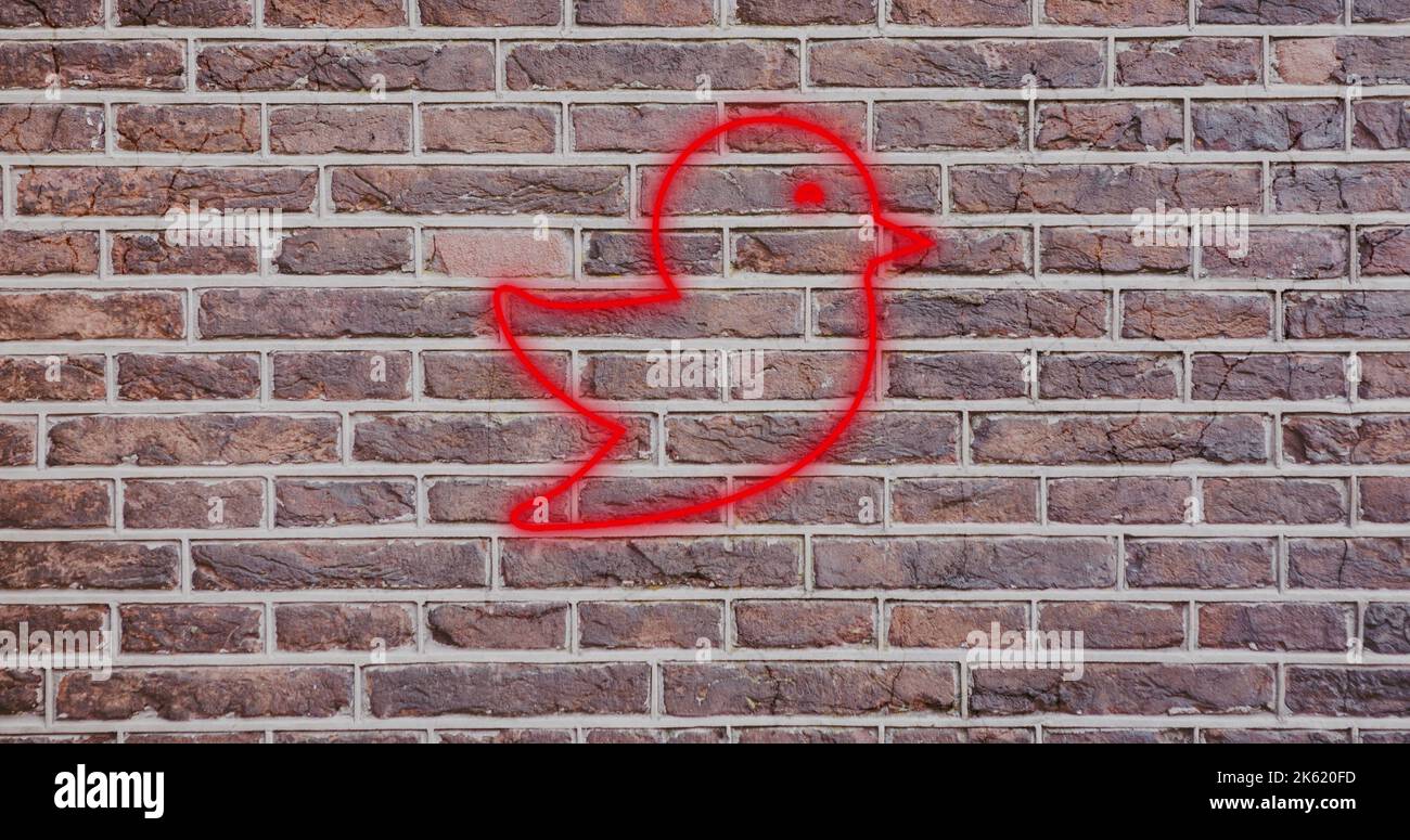 Composite of digital illuminated red bird icon against brick wall, copy ...