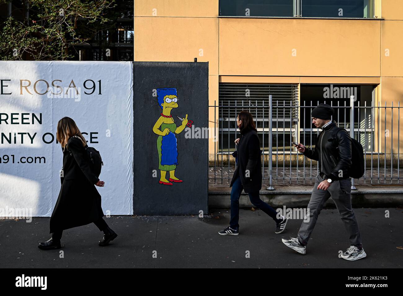Milan, Italy - October 11, 2022: People walk past a mural entitled ‘The ...
