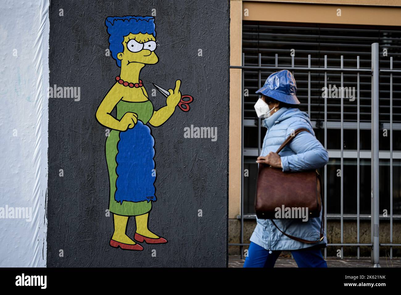 Milan, Italy - October 11, 2022: A woman walks past a mural entitled ...