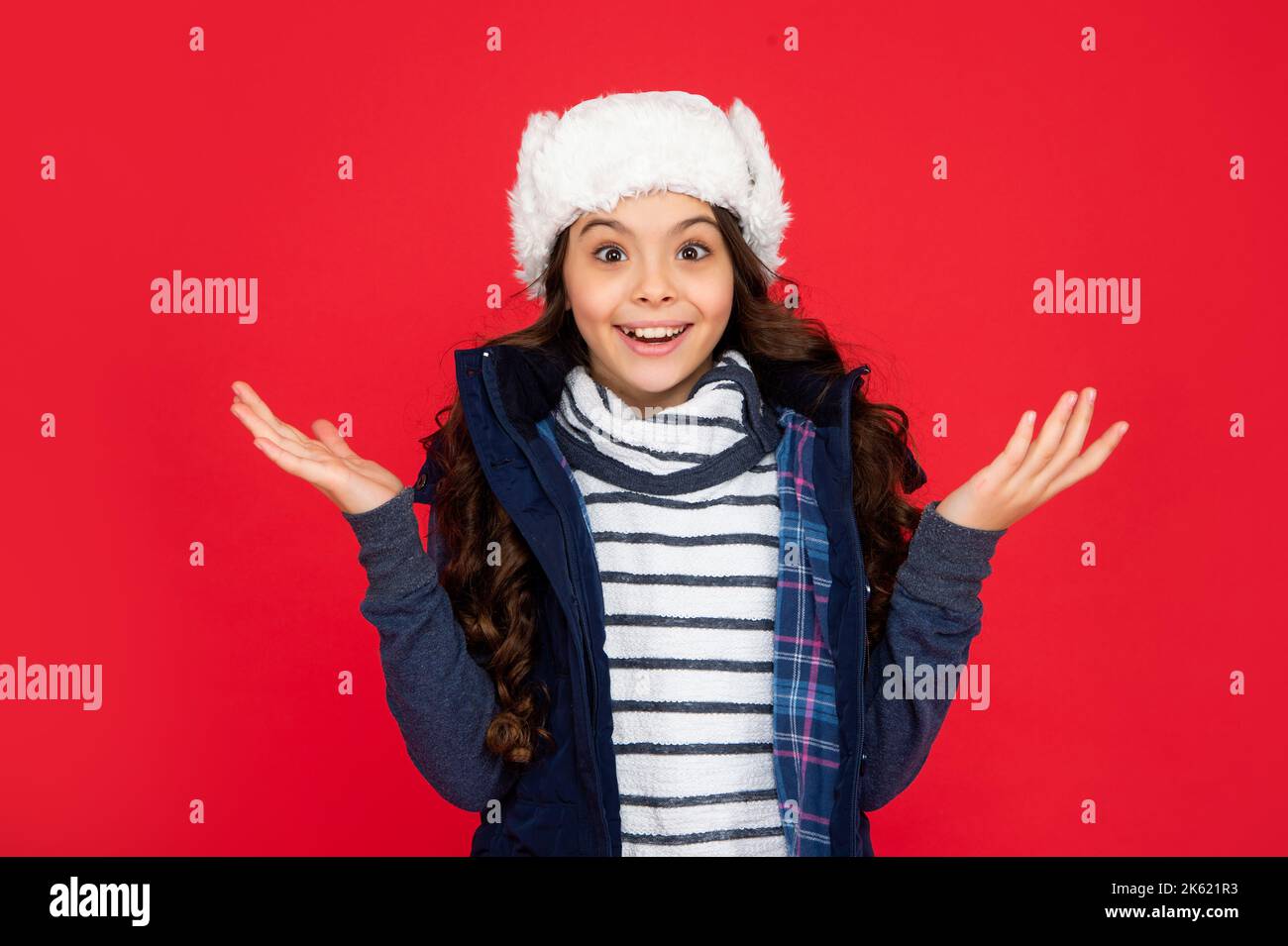 portrait of child wearing warm clothes. express positive emotion ...