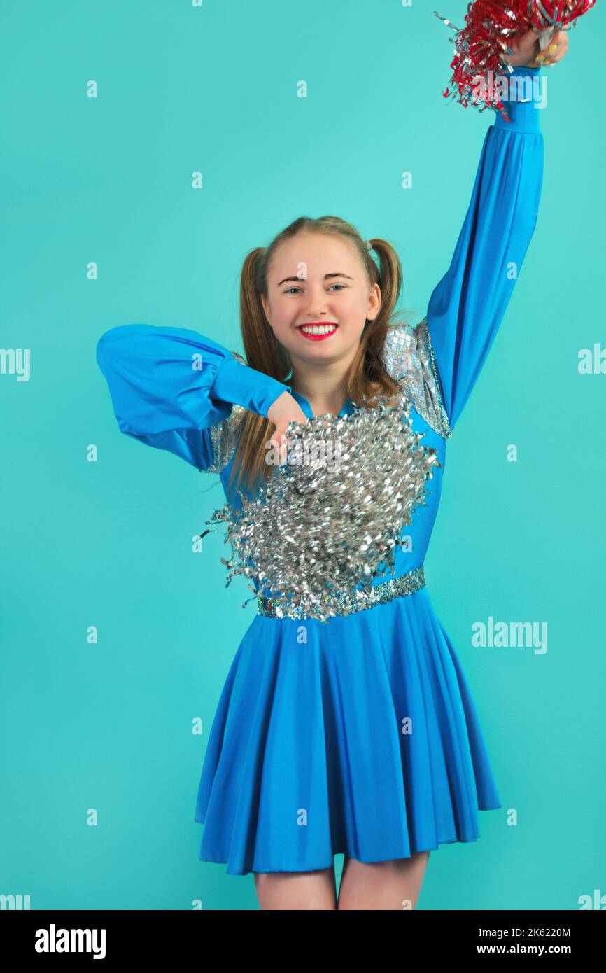 portrait of young cheerleader girl from cheerleading group. turquoise ...
