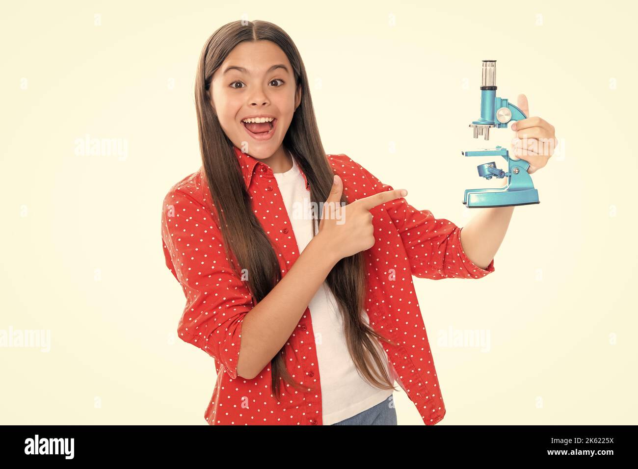 Teen school girl with microscope for school education on white ...