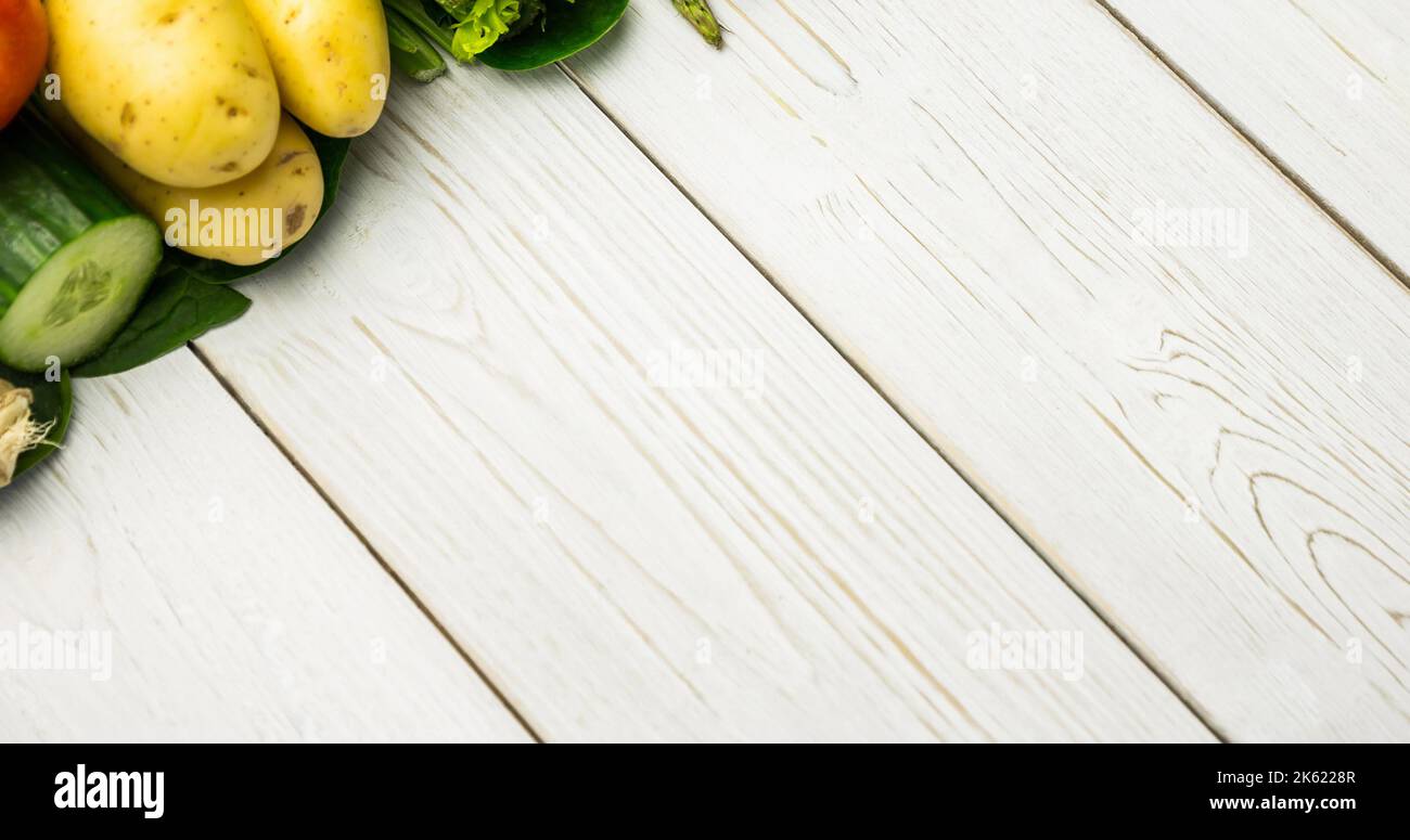 High angle view of fresh raw vegetables on wooden table, copy space ...