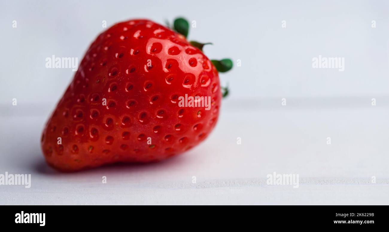 Close up of fresh strawberry over white wooden table, copy space Stock ...