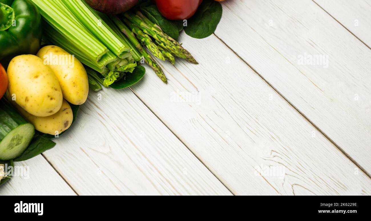 High angle view of various fresh raw vegetables arranged wooden table ...