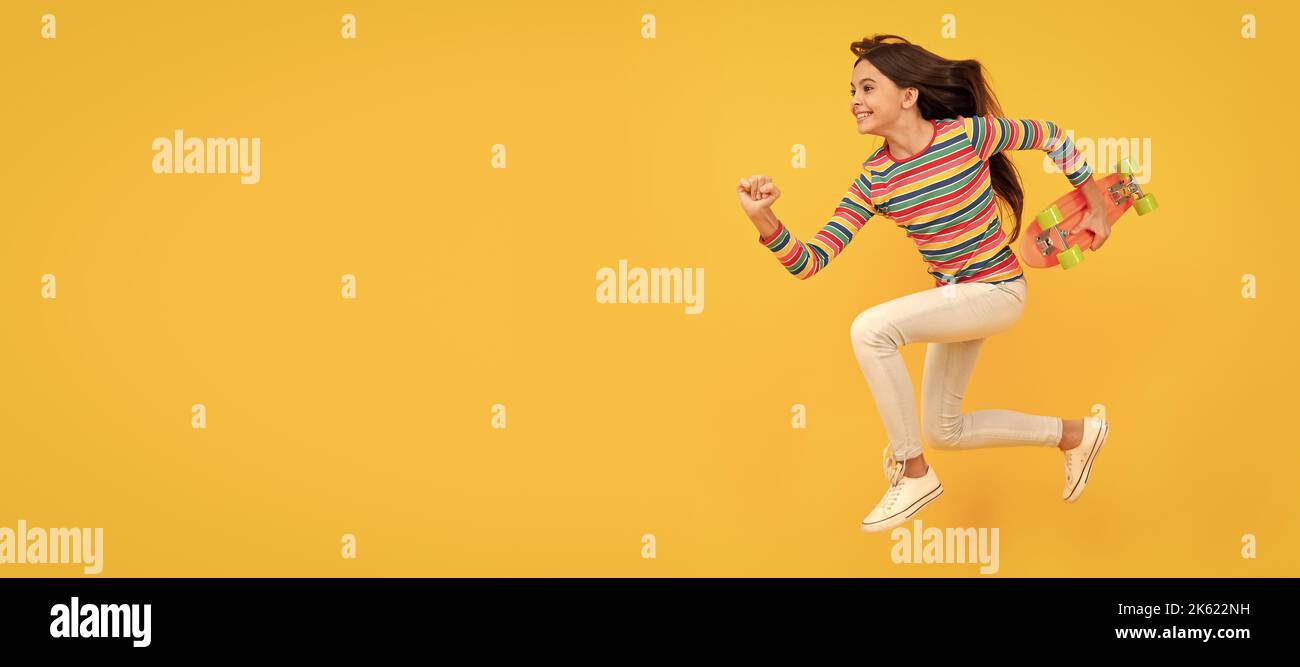 Run and jump. happy energetic teen girl skateboarder jumping with penny ...