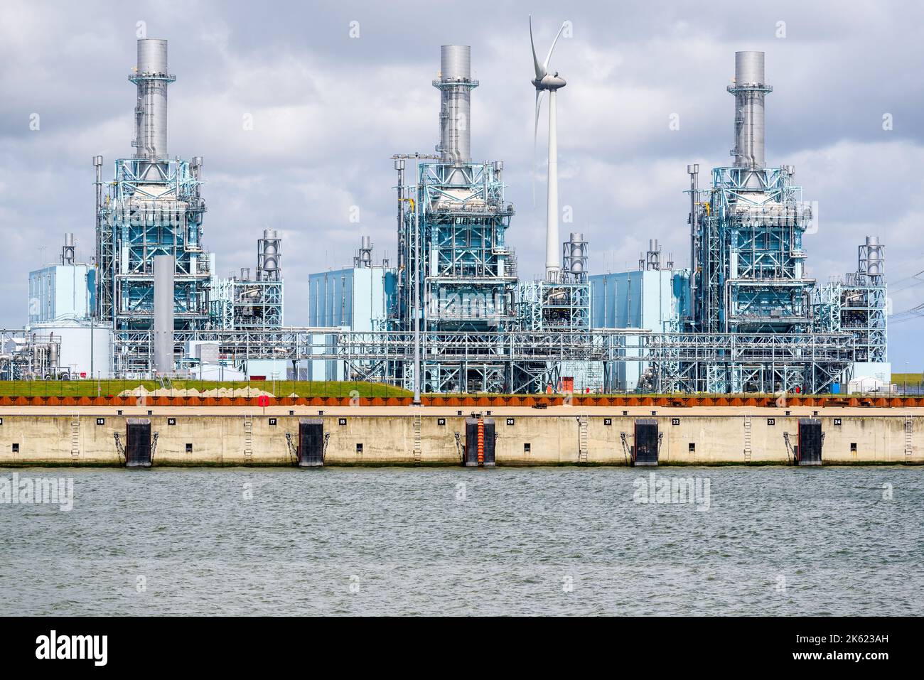 Gas fired power station on a harbor on a cloudy summer day. A wind ...