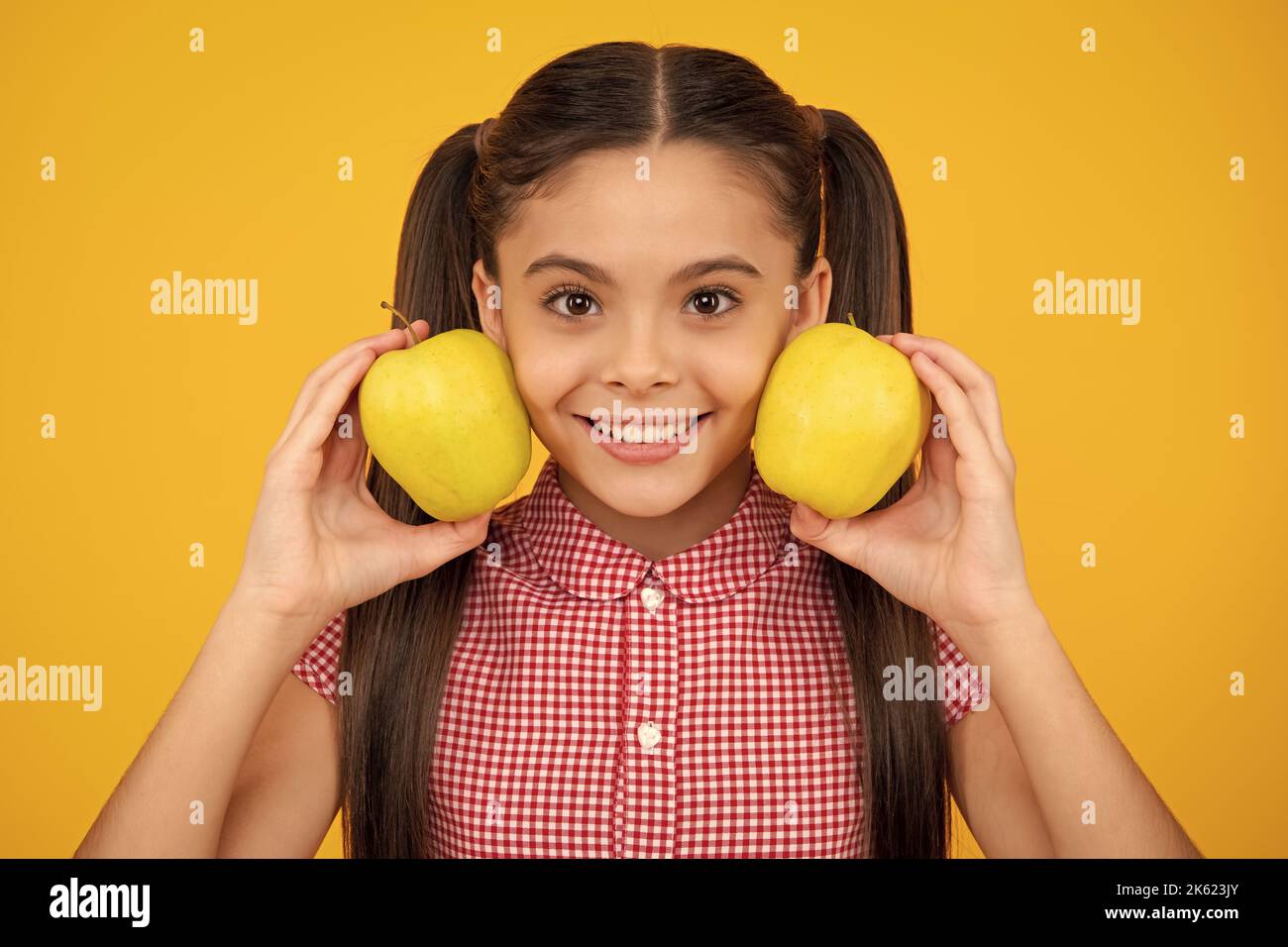 Teenager child with apple on yellow isolated background. apples are ...