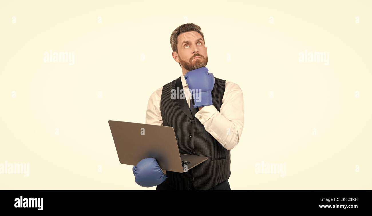 pondering man in boxing gloves and suit hold laptop isolated on white ...