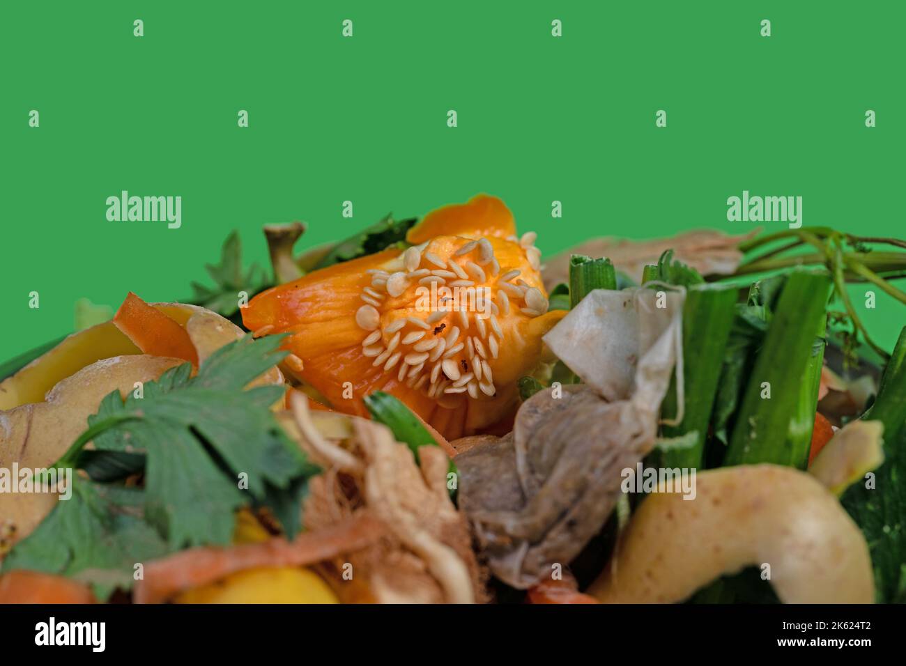 Organic waste for composting against a green background Stock Photo - Alamy