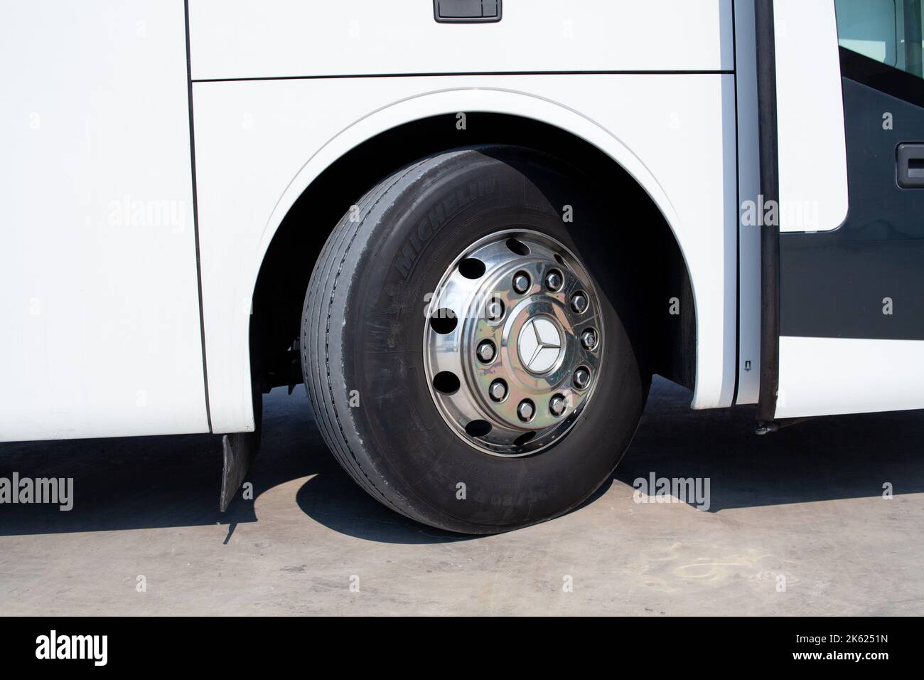 Huge bus wheel with a shiny disc. White bus wheel arch. Michelin tire ...