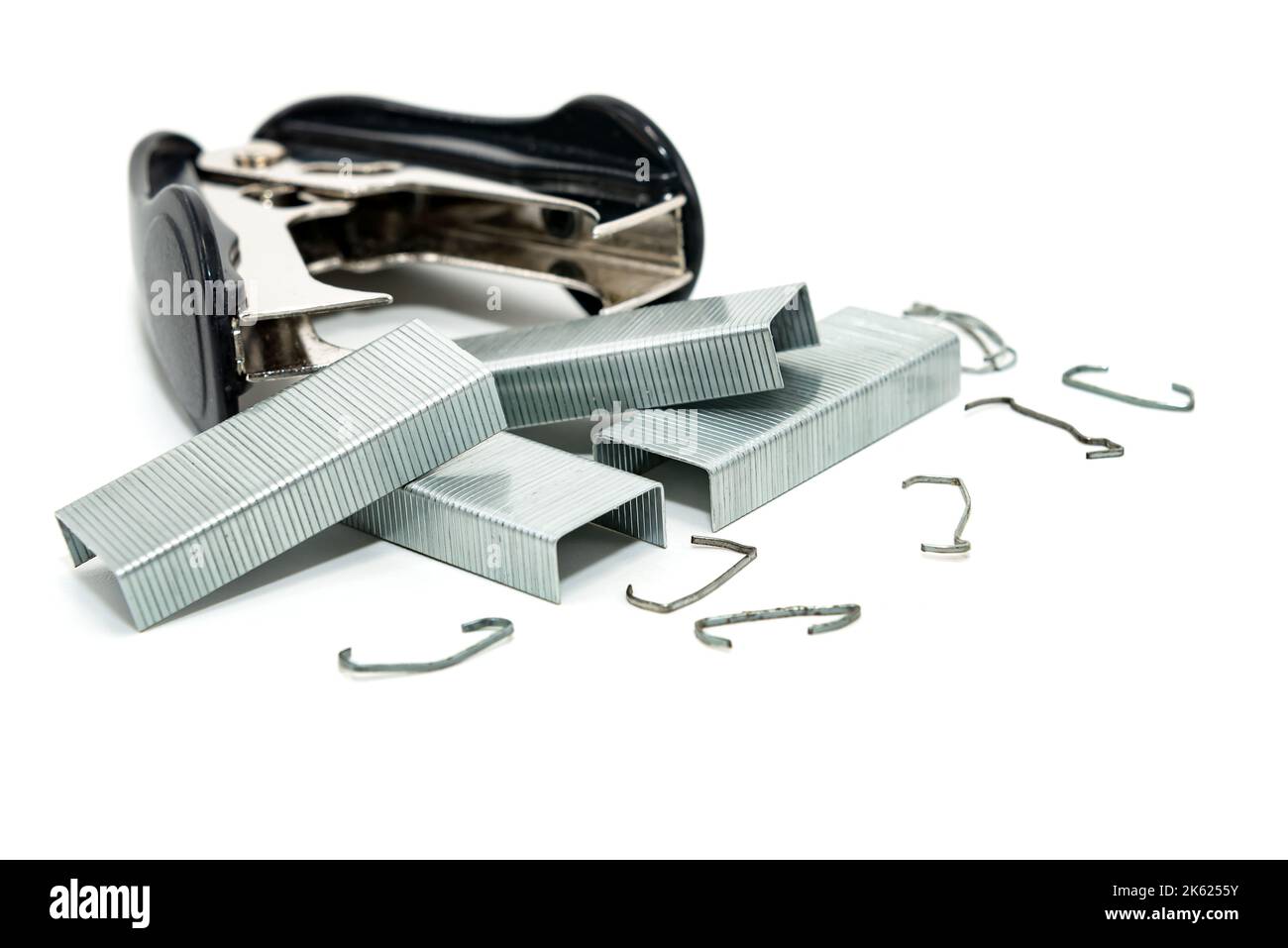 Stapler and anti-stapler with staples on a white background. Office ...