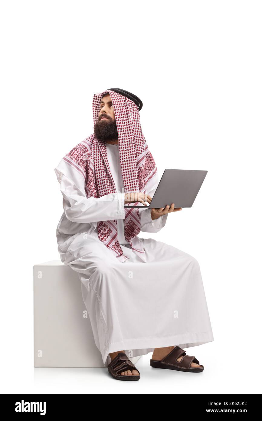 Saudi arab man with a laptop computer sitting and looking back isolated ...
