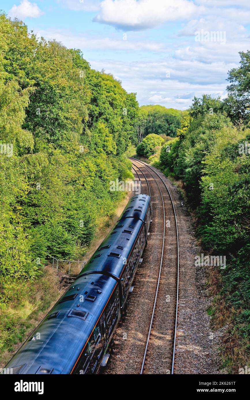 A GWR passenger train travelling through the Surrey Hills countryside ...