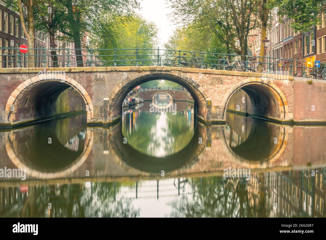 Netherlands. Morning on the Amsterdam Canal. Series of bridges with ...