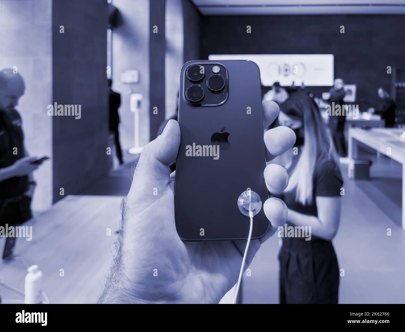 Paris, France - Sep 16, 2022: POV male hand holding new purple colored ...