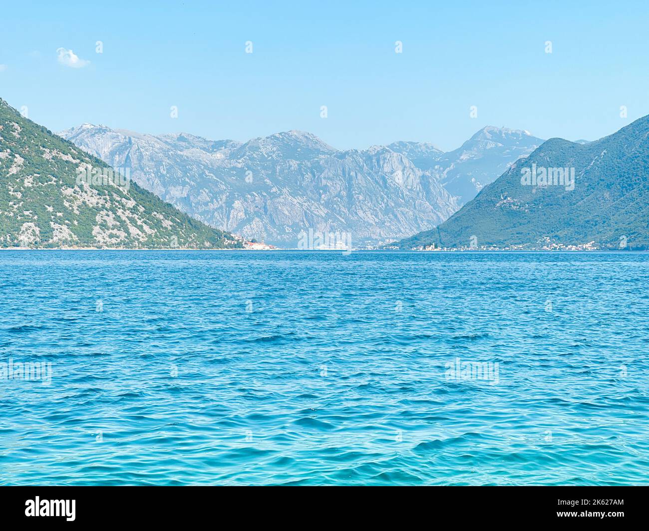 A scenic view of the sea with mountains in the background Stock Photo ...