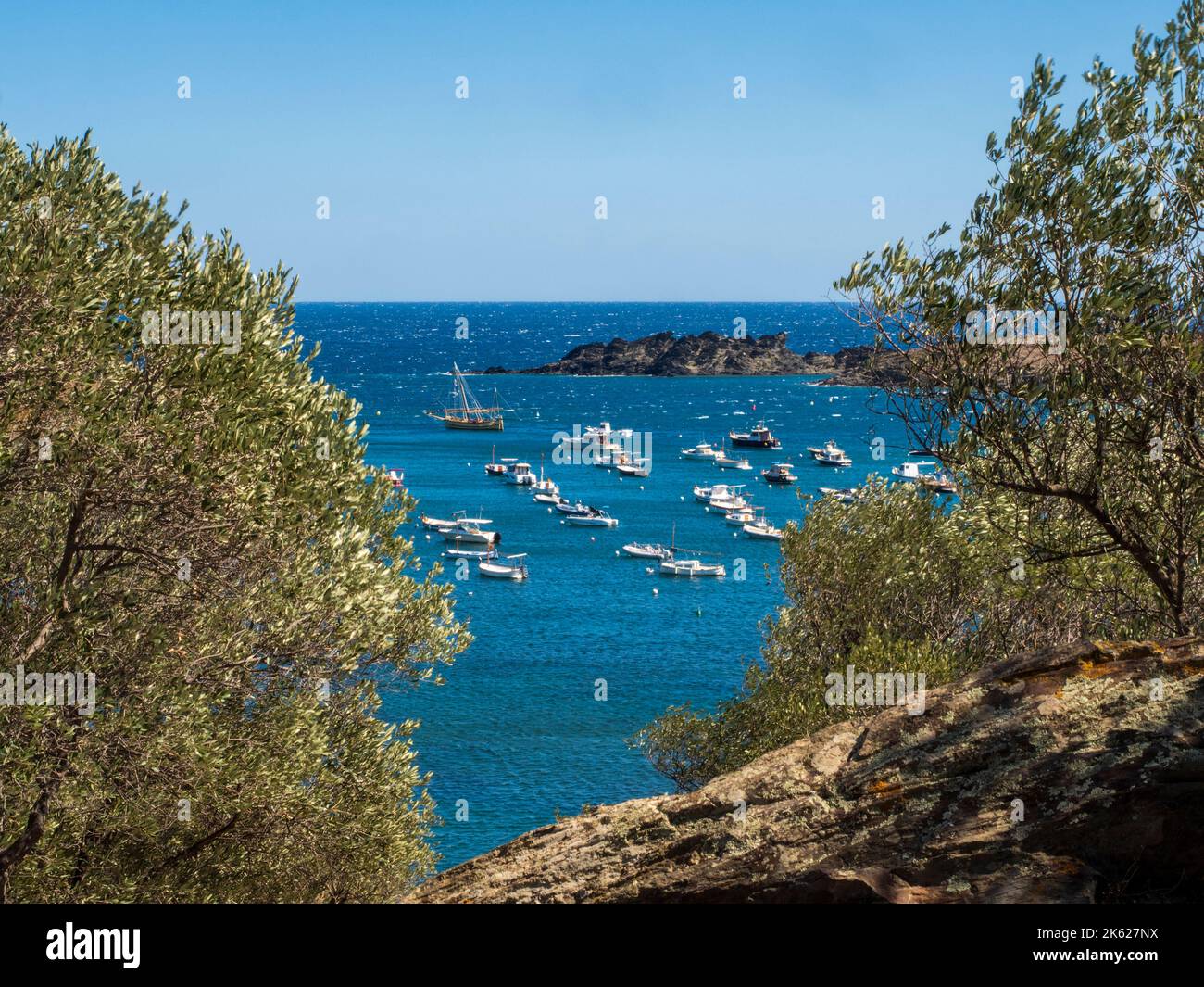 View of the bay of Cadaqués filled with boats Stock Photo - Alamy