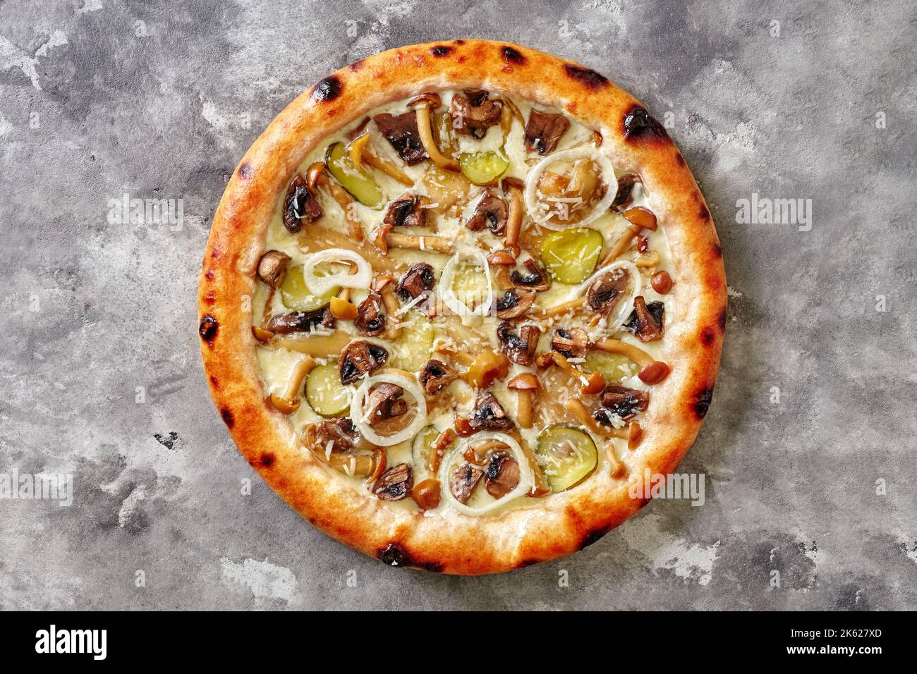 Freshly mushroom pizza with onions, pickled cucumbers, grated parmesan ...