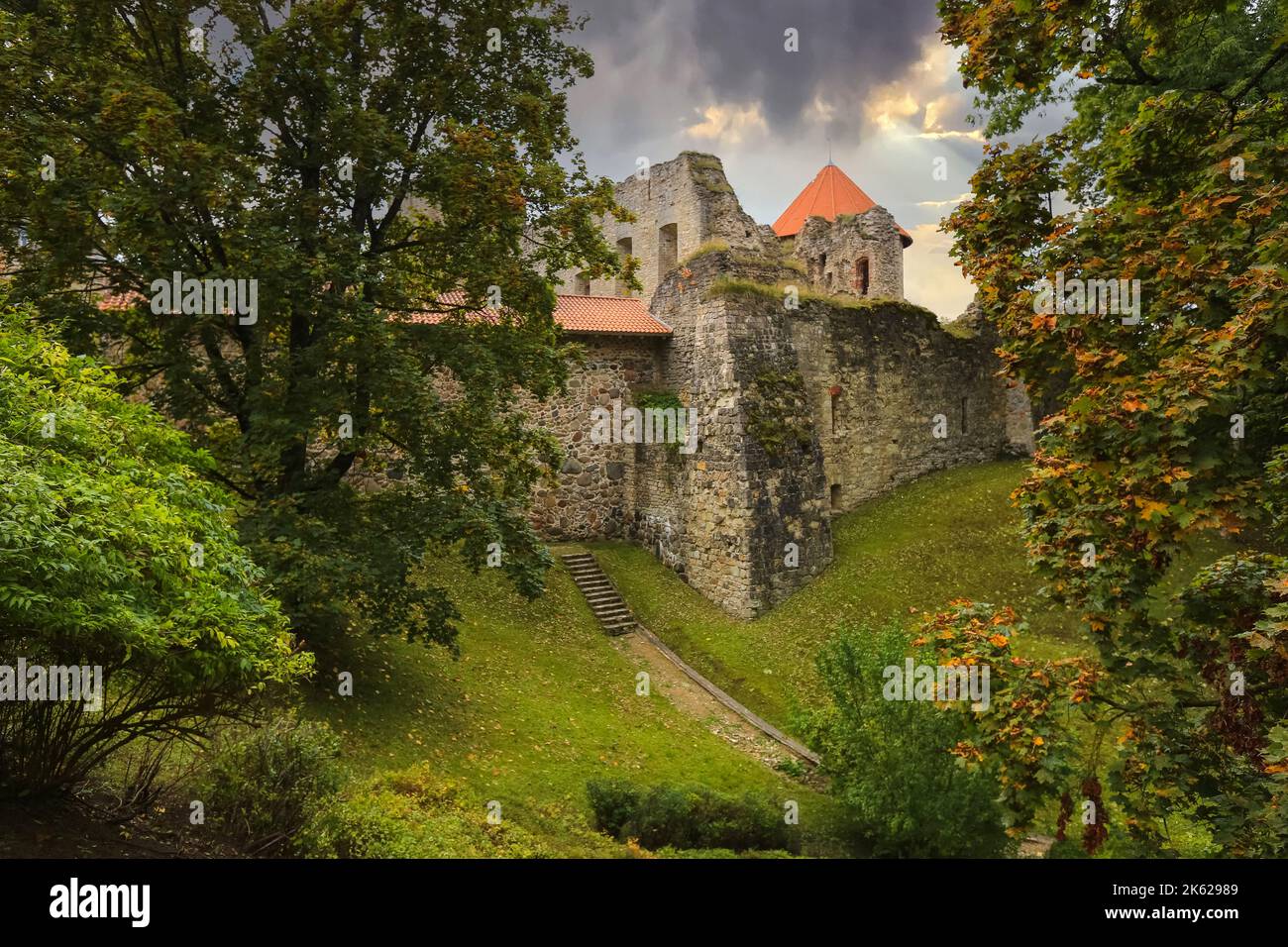Autumn park and abandoned medieval castle in the town Cesis which has ...