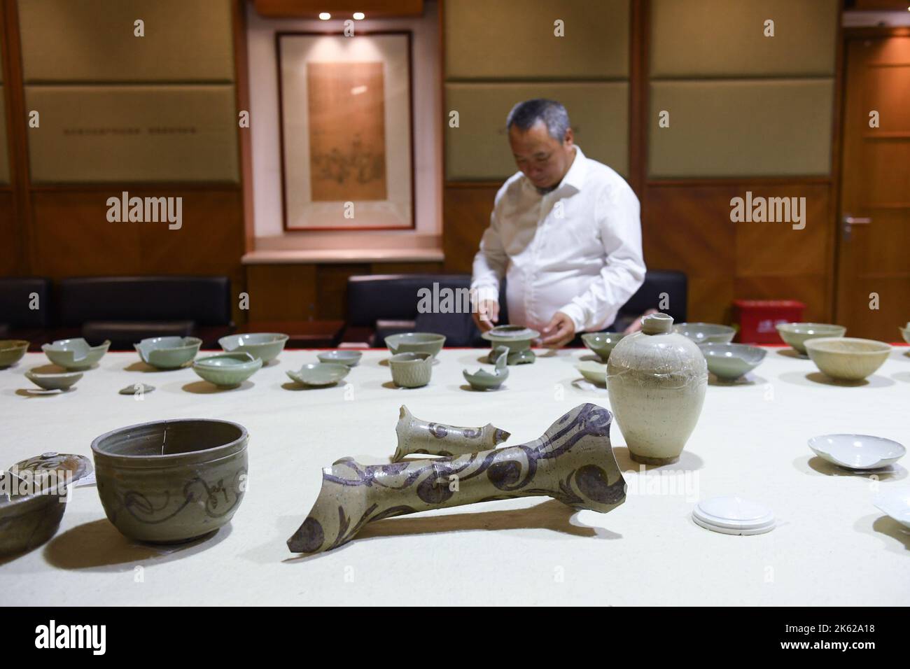 WENZHOU, Oct. 11, 2022 (Xinhua) -- A researcher checks the ceramics ...