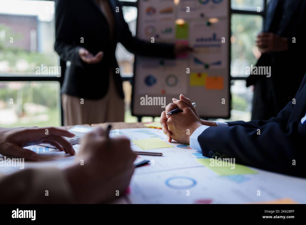 Asian Business people or Accountant do math and analyze with calculator ...