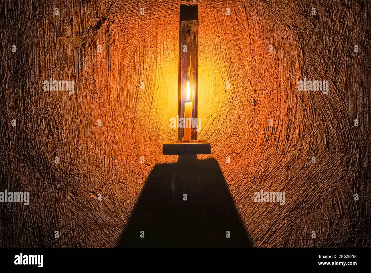 Candle lighting on a small lever and its trapeze shadow Stock Photo - Alamy