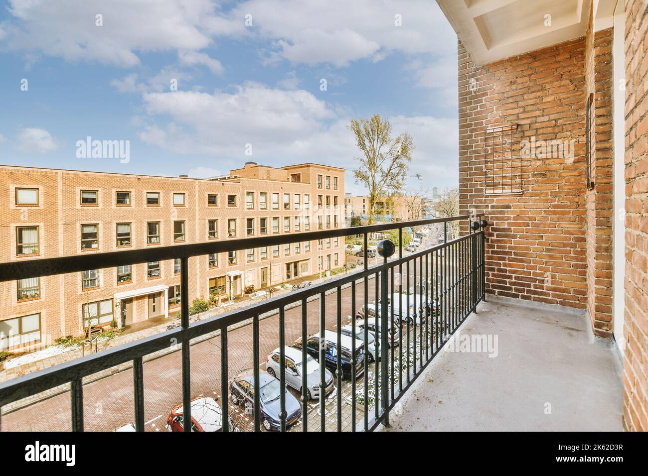 Narrow brick balcony with metal railings and door Stock Photo - Alamy