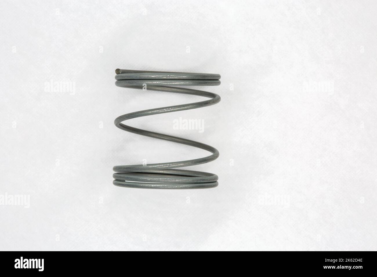 Metal spring coil closeup on white Stock Photo - Alamy