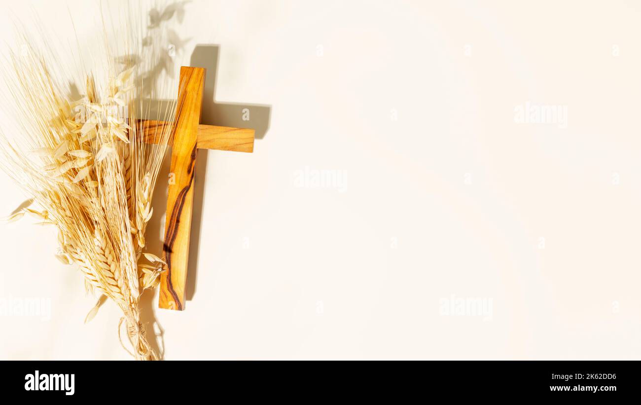 Wooden crucifixion with bouquet of wheat and rye with copy space Stock ...