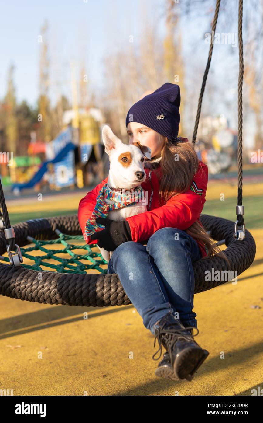 Happy child girl with dog. Portrait kid with pet Jack Russell Terrier ...