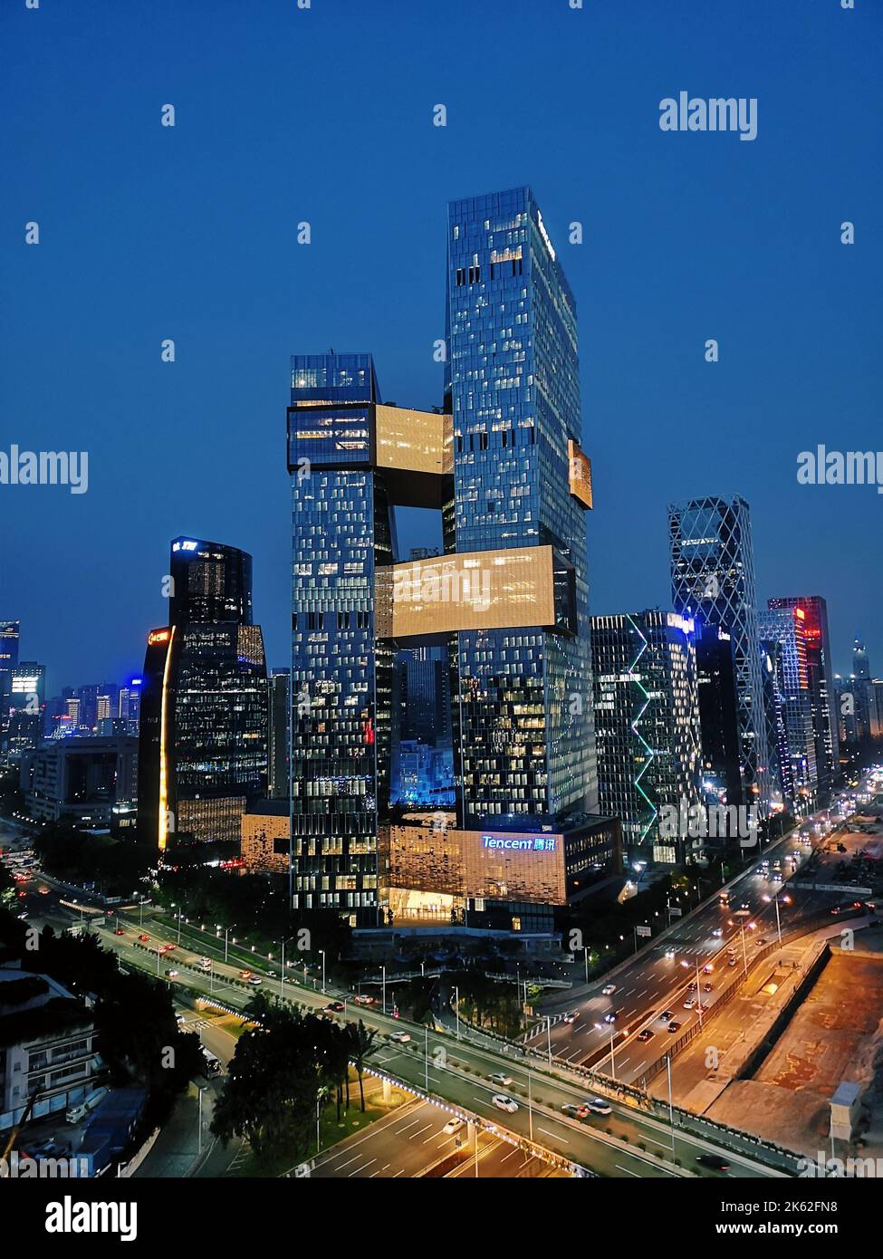 A vertical view of the buildings of Tencent under the blue evening sky ...