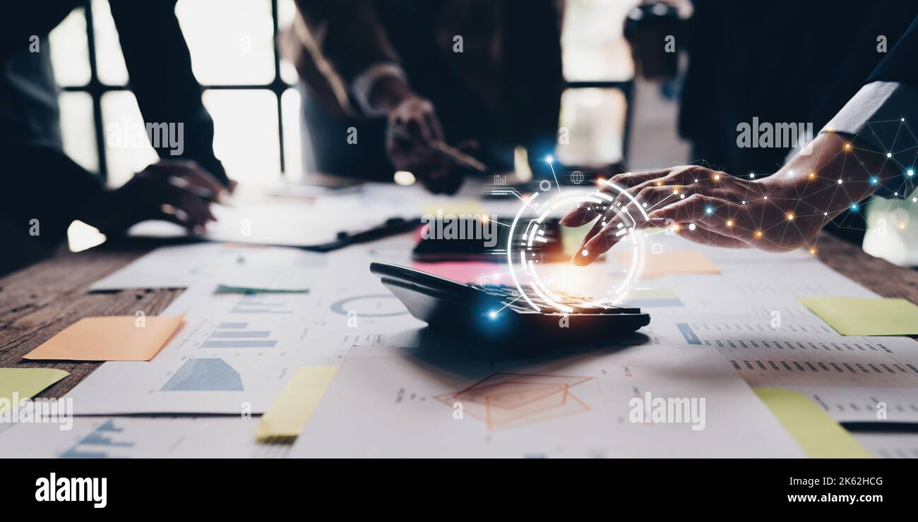 Asian Business Woman or Accountant do math and analyze with calculator ...