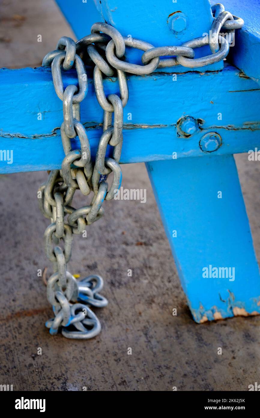 Chain wrapped around legs of blue table for security and protection ...