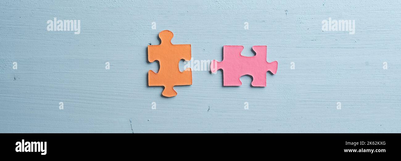 Wide view image of two blank orange and pink matching puzzle pieces ...