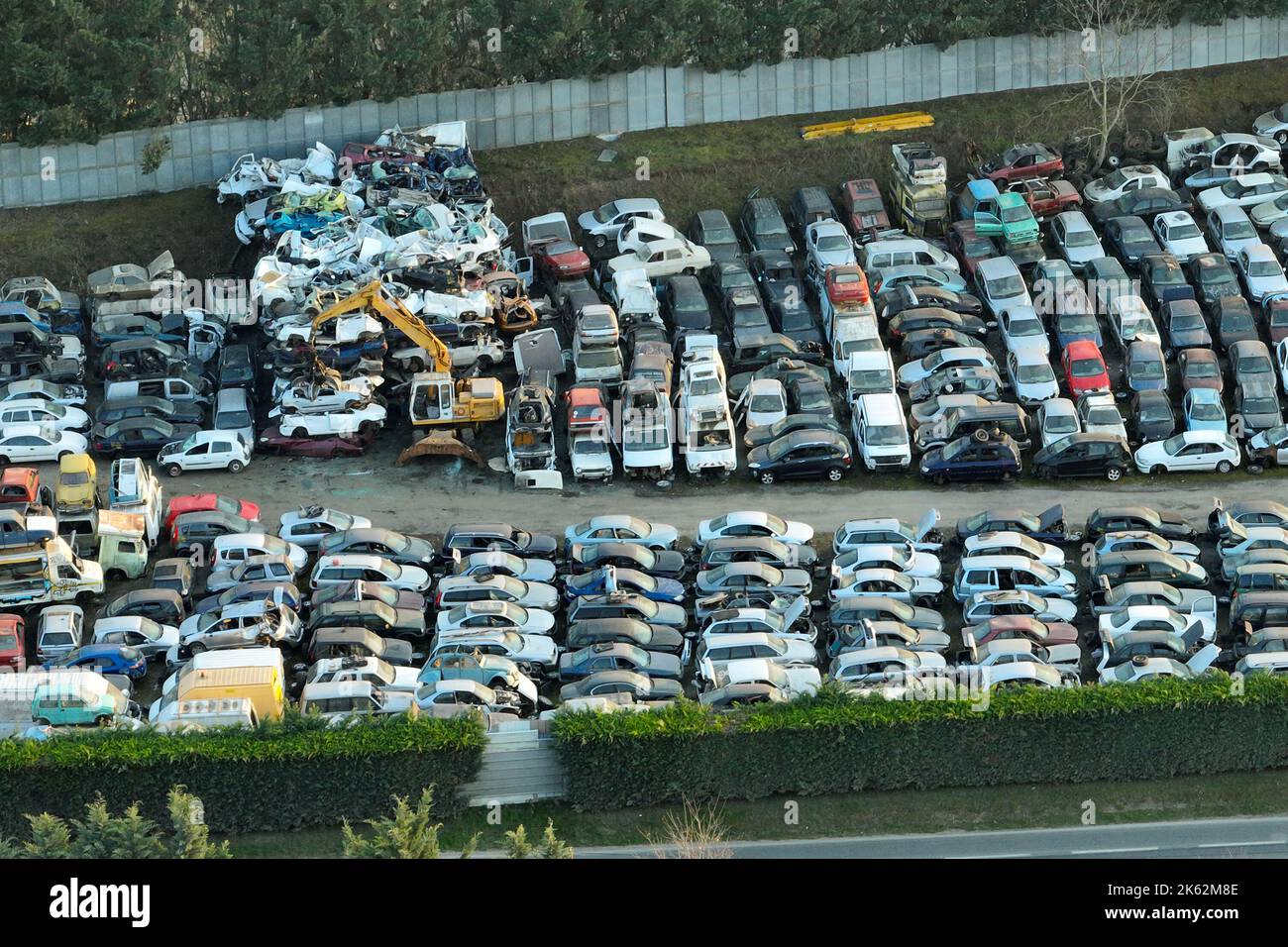 Aerial view of big parking lot of junkyard with rows of discarded ...