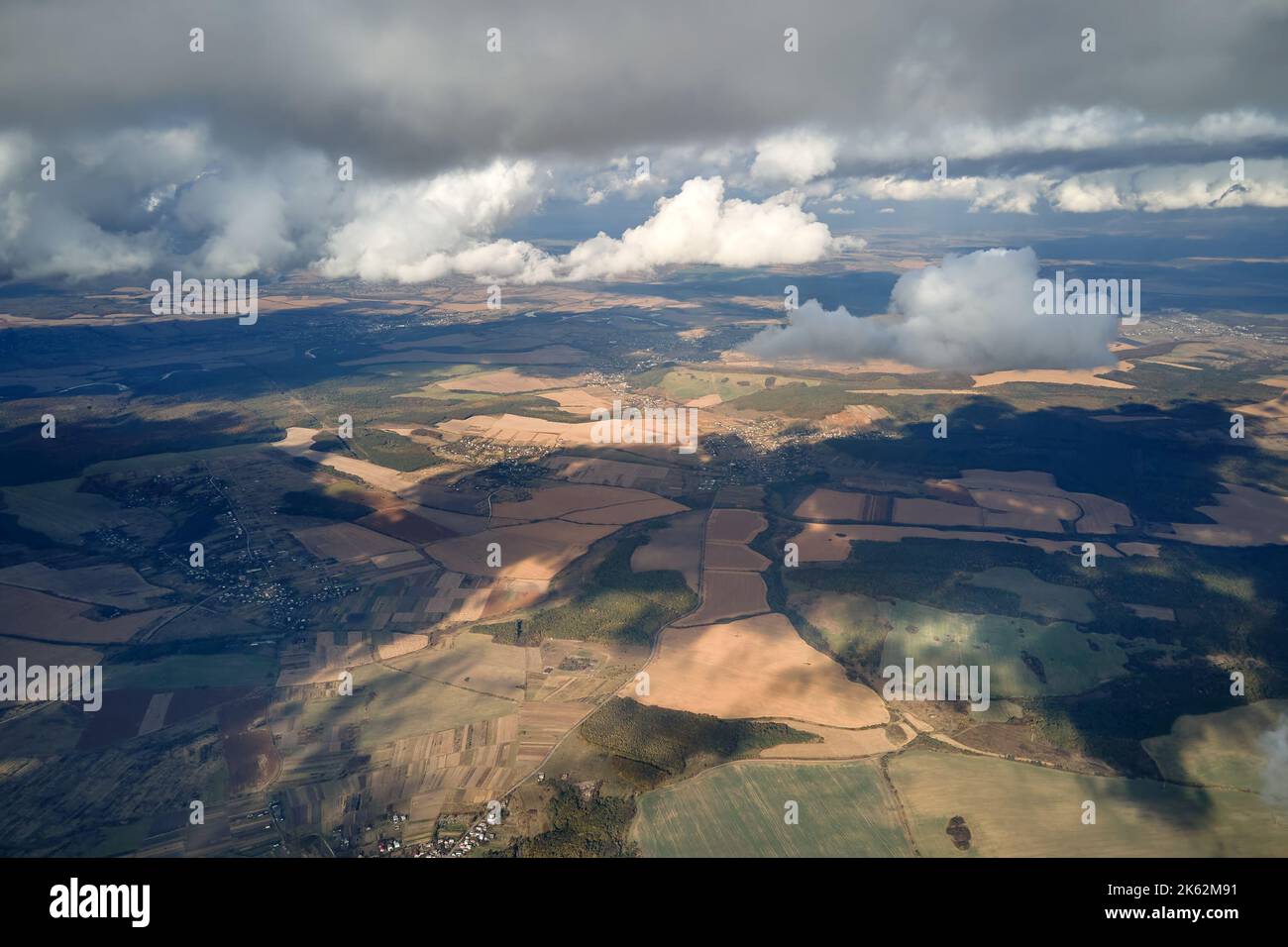 Aerial view from airplane window at high altitude of earth covered with ...