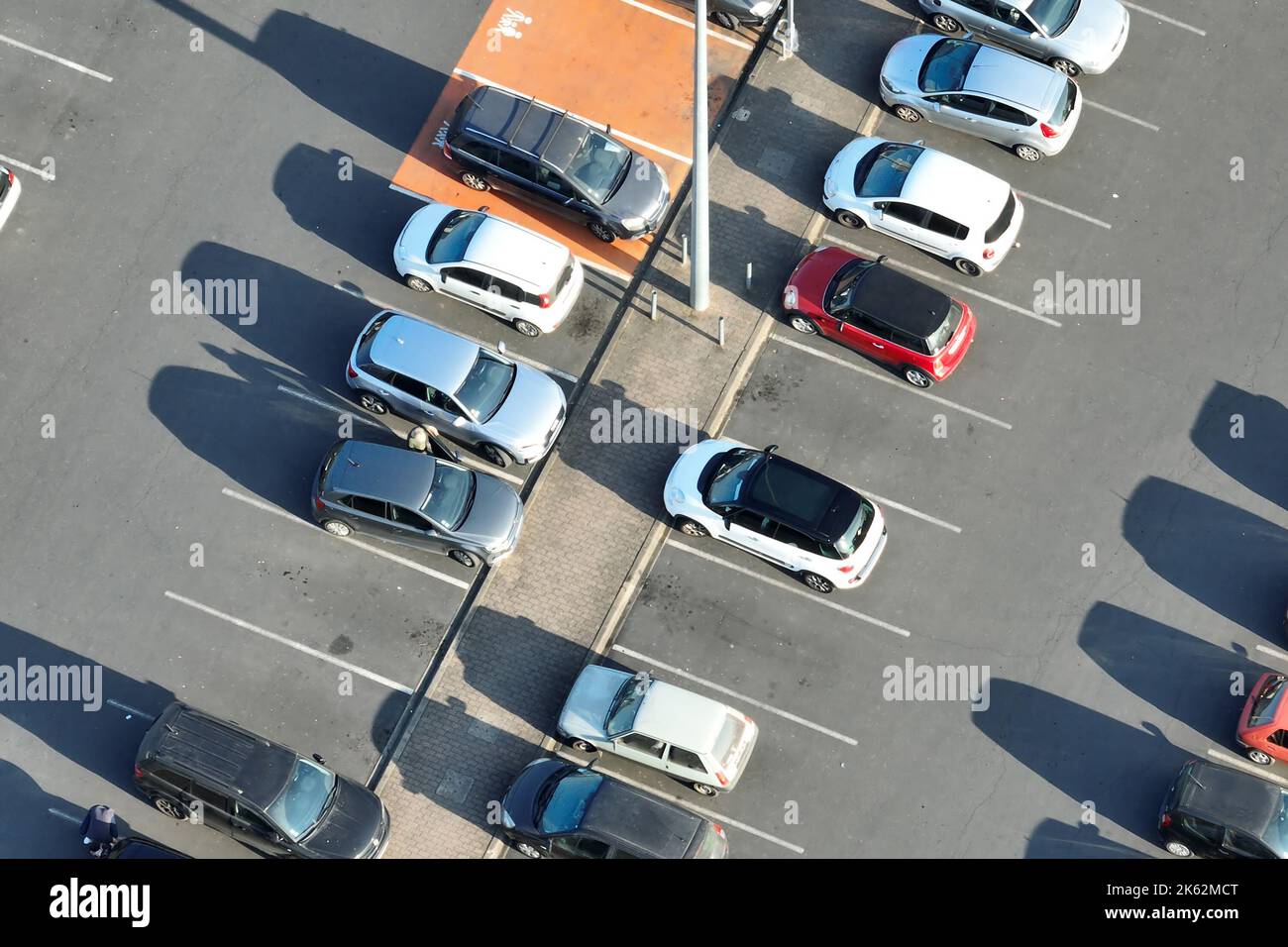 Aerial view of many colorful cars parked on parking lot with lines and ...