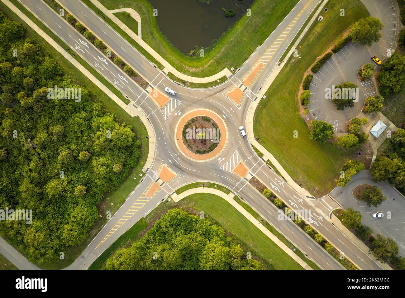 Aerial view of road roundabout intersection with moving cars traffic. Rural circular ...