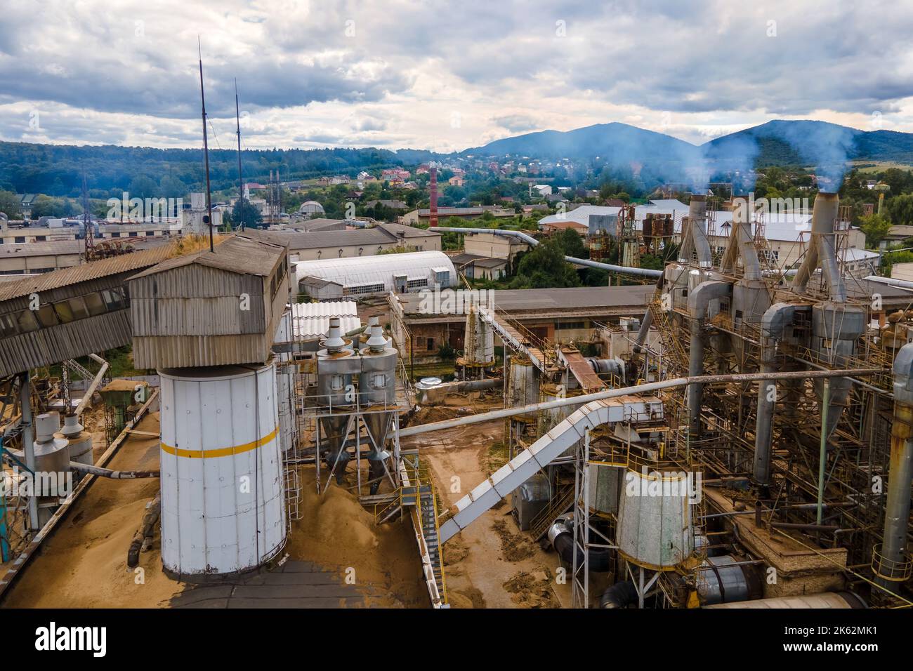 Aerial view of wood processing factory with smoke from production ...
