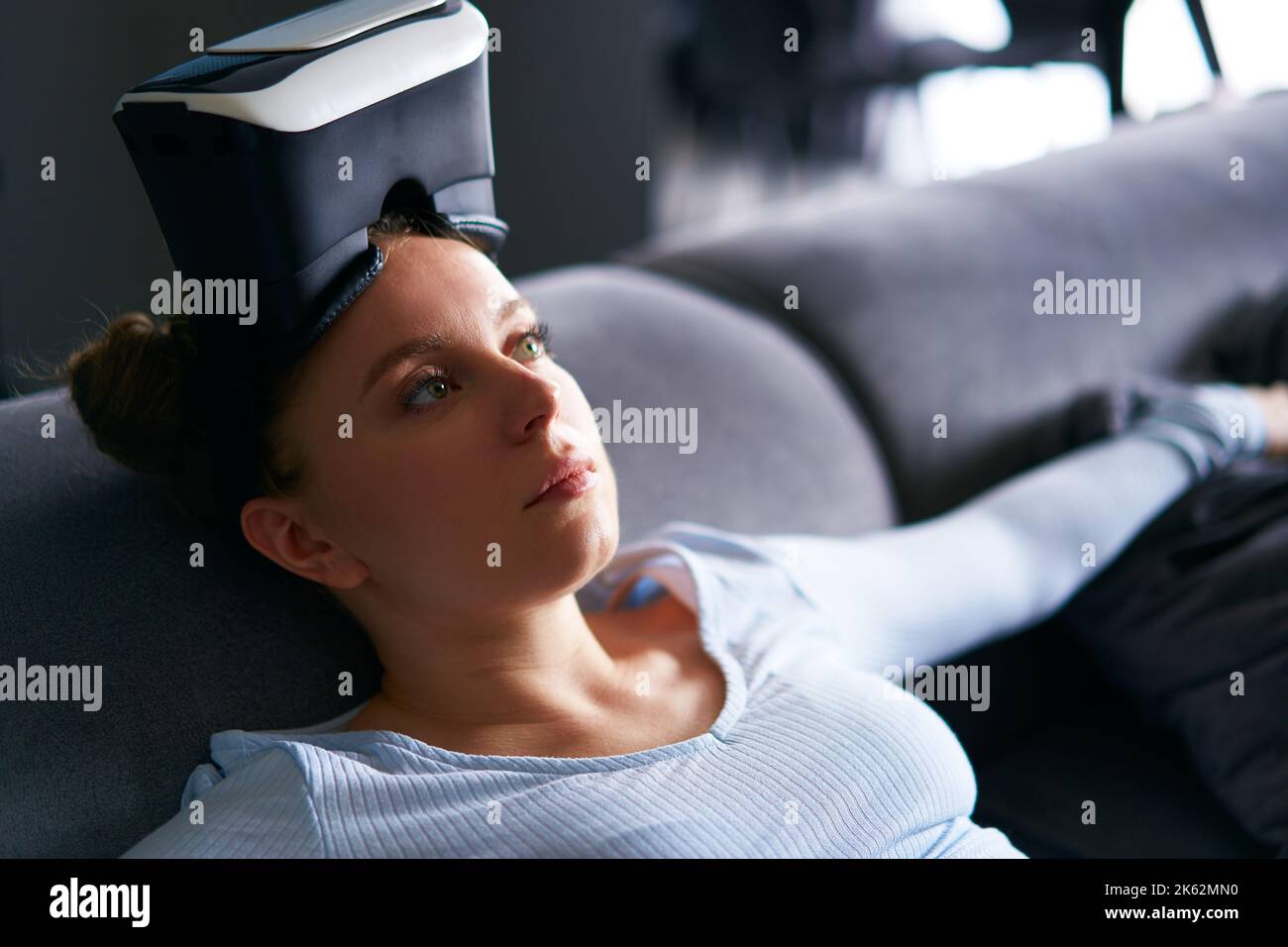 Robot like futuristic doll woman in virtual reality goggles interface ...