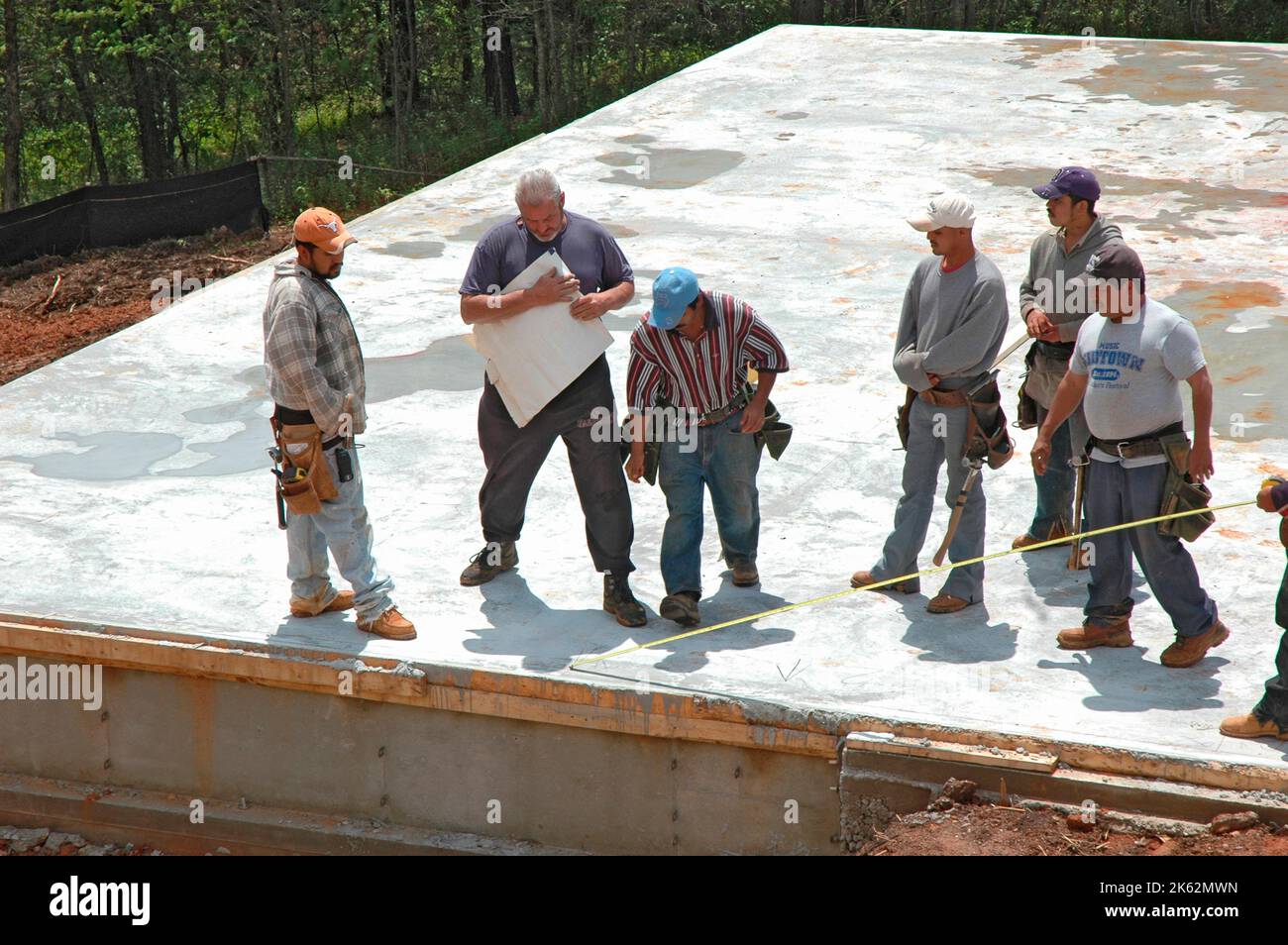 Crew getting layout instructions to put up wood walls on new home ...